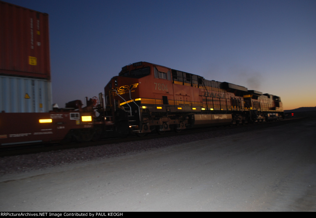 BNSF 7804 heads west pushing a westbound Z-Train behind BNSF 7910 the Lead unit at Sunrise as ...